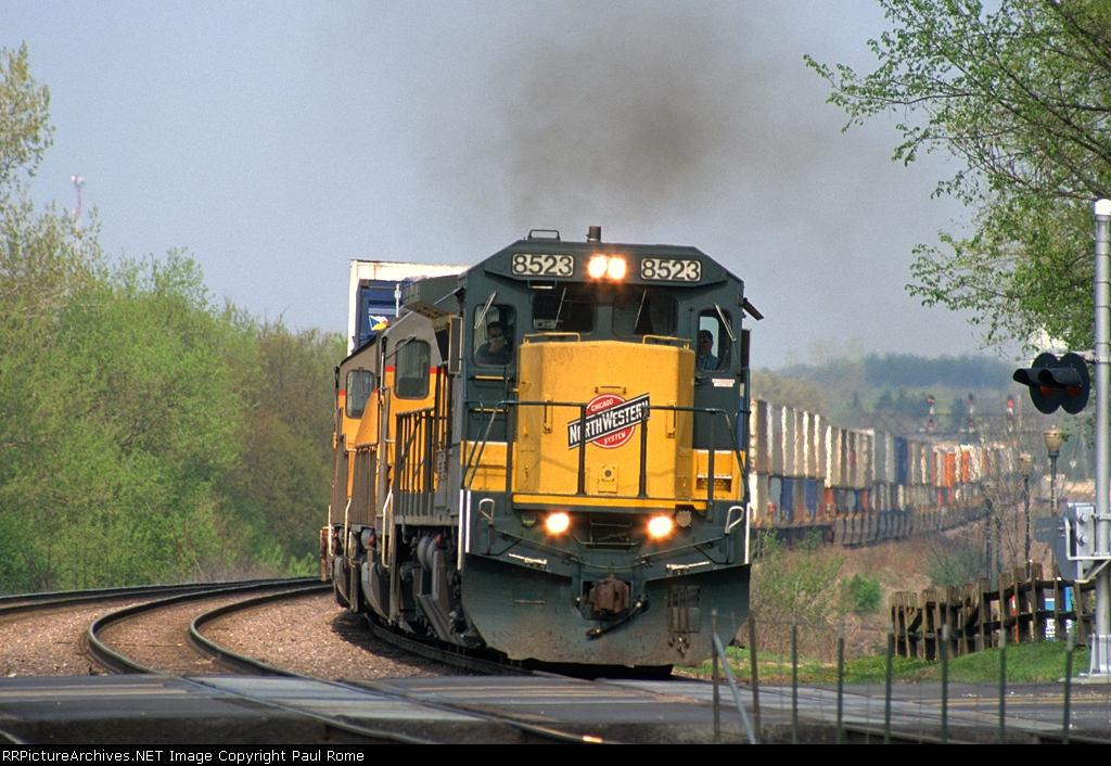C&NW 8523, GE C40-8 leads an eastbound double-stack train